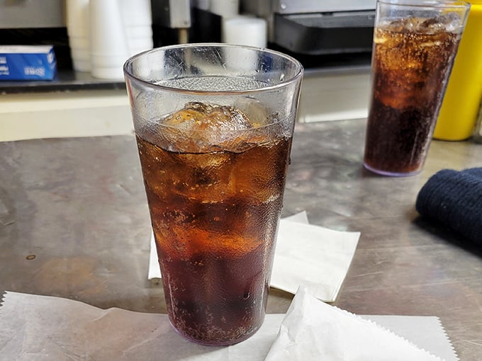 That ice-cold Coca-Cola in a no-nonsense glass isn't just a beverage; it's the perfect companion to cut through the richness of a Cheesy Western.