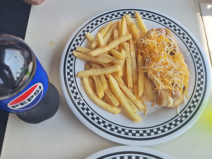 The classic combo &ndash; a cheese-topped dog, perfectly golden fries, and an ice-cold Pepsi. Some traditions don't need reinvention, just appreciation.