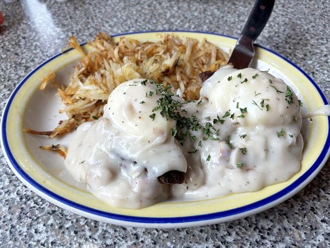 Country-style benedicts smothered in creamy gravy with crispy hashbrowns on the side—cardiac care has never looked so worth it.