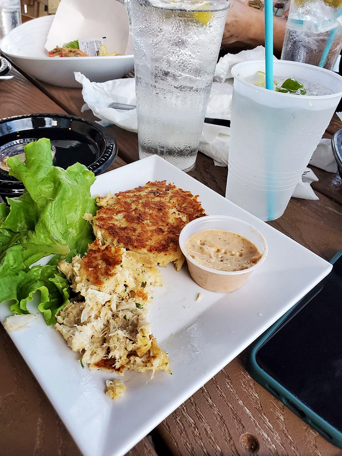 Crab cakes that actually taste like crab – a culinary miracle worth crossing state lines for. The sweet potato fries are just a bonus.