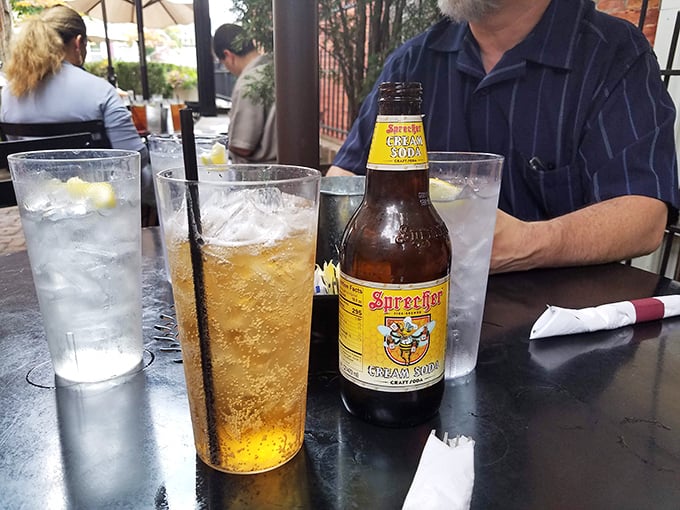 Sprecher's Cream Soda—the Midwest's answer to champagne—fizzing with anticipation in a glass that catches afternoon light like liquid amber.