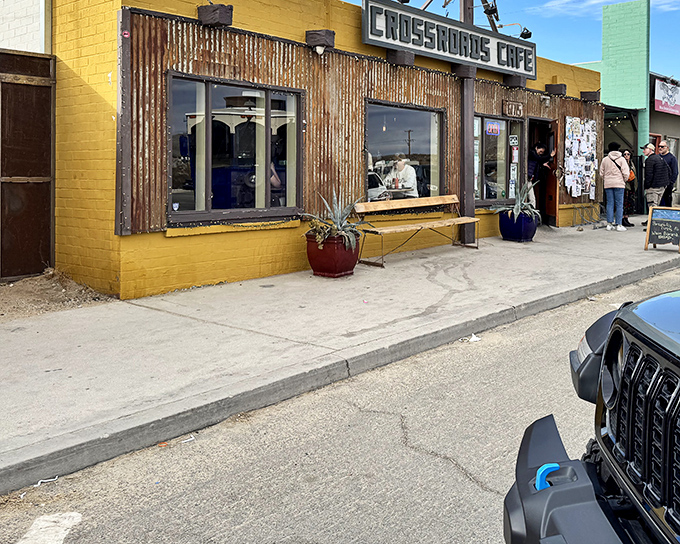Crossroads Caf&eacute;'s bright yellow exterior promises comfort food with desert flair. The rustic corrugated metal adds that perfect touch of authenticity.