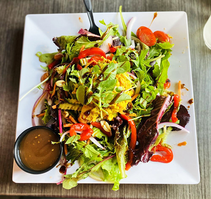 This isn't just salad&mdash;it's a vibrant garden party on a plate, with the dressing waiting patiently in its little black dress of a container.