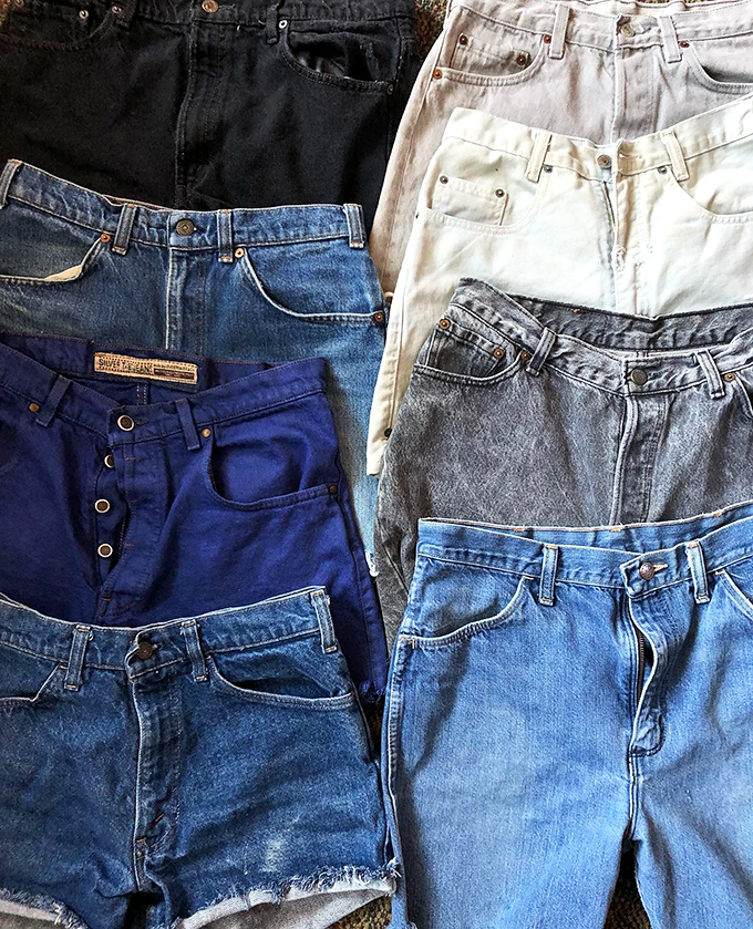 Denim heaven arranged like a blue jean rainbow. Each pair carries the ghosts of adventures past and promises new stories waiting to be written.