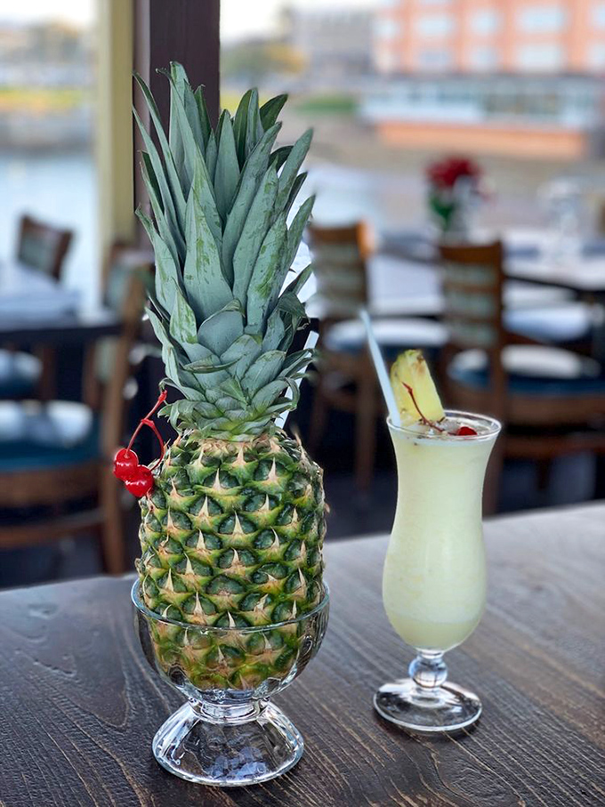 A tropical drink beside a whole pineapple&mdash;because sometimes your beverage deserves its own well-dressed companion.