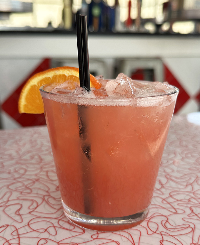 That rosy cocktail isn't just refreshing—it's what happens when your bartender takes the "brew" part of the name as seriously as the "burger" part.