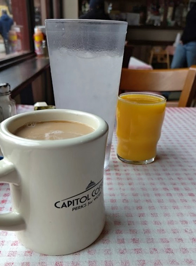 Morning beverages at Big Ed's: where coffee comes in mugs substantial enough to double as workout equipment and orange juice glows like liquid sunshine.