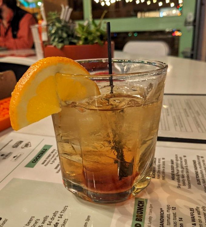 An old fashioned with a fresh orange slice &ndash; because sometimes the perfect chaser to smoky BBQ is a classic cocktail with a citrus wink.