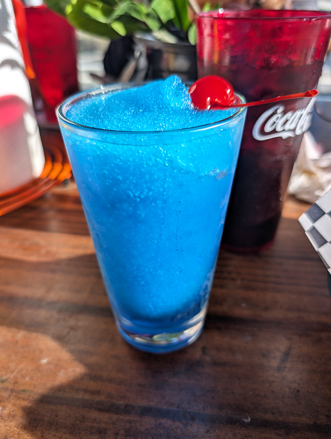 That electric blue cocktail isn't just a drink&mdash;it's a vacation in a glass. Paired with a cherry that's having its own little tropical getaway.