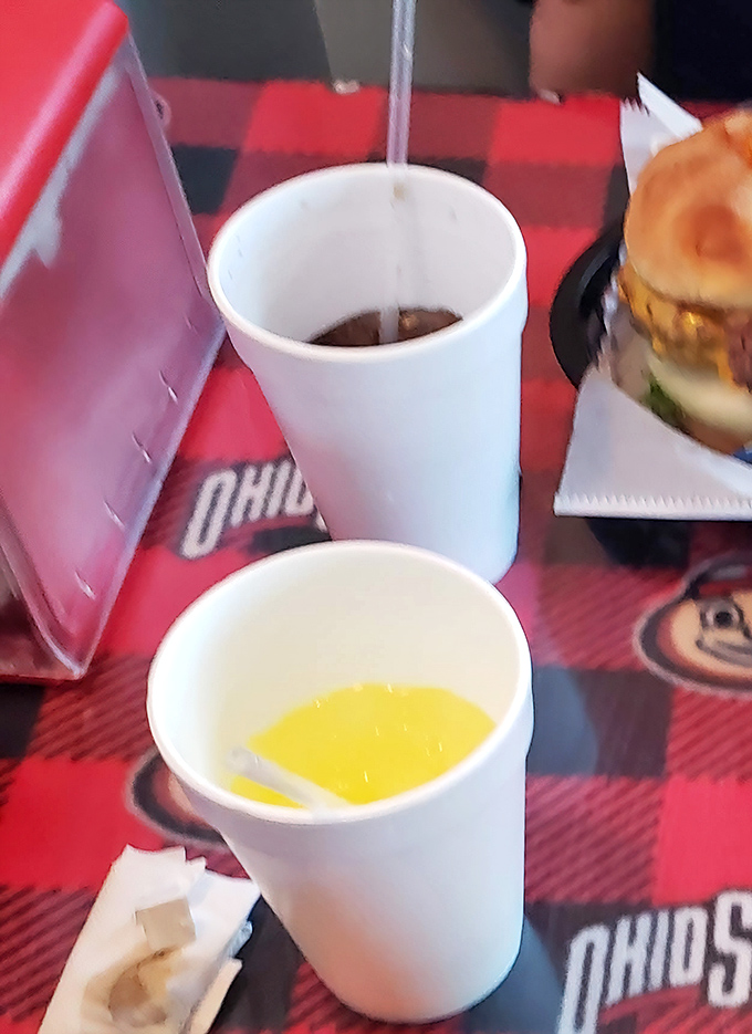Even the drinks come with a side of Buckeye pride. That red-checkered tablecloth has seen more Ohio State celebrations than most stadiums.