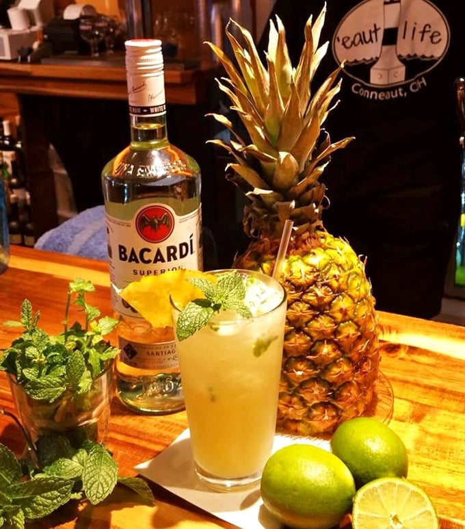 Cocktail artistry in full swing&mdash;where fresh mint, pineapple, and rum come together like old friends planning a beach vacation in your mouth.