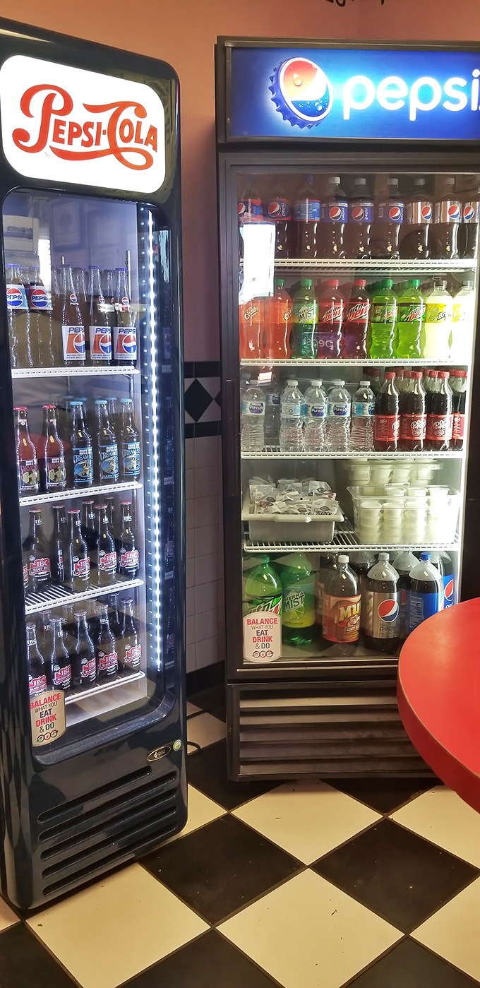 The vintage soda display isn't just refrigeration&mdash;it's a museum of fizzy happiness where Pepsi-Cola history meets modern thirst.