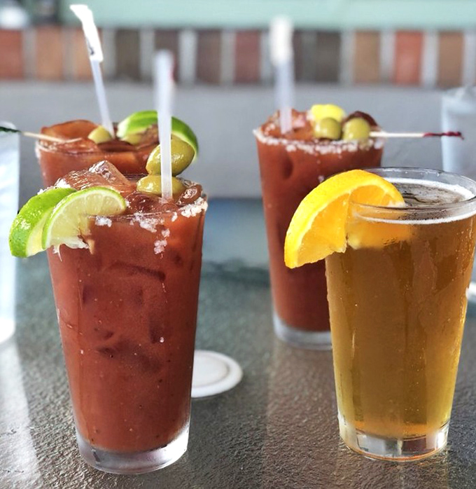 Bloody Marys garnished with enough citrus to prevent scurvy, alongside a beer that's the color of Florida sunshine in a glass.