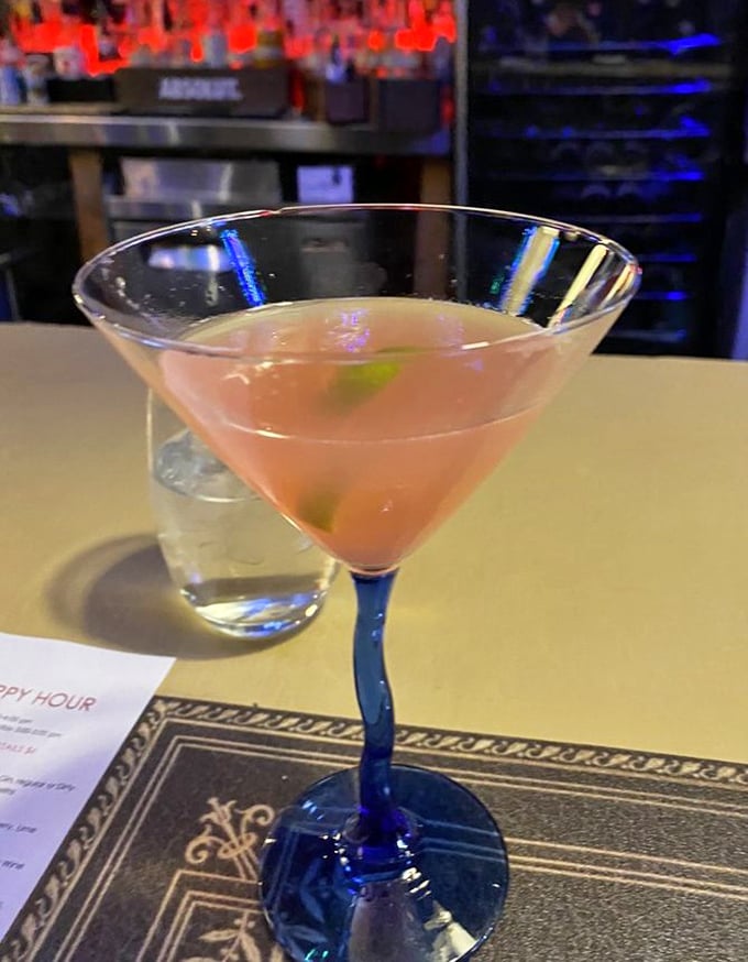 Cocktail craftsmanship in a blue-stemmed glass. This isn't just a drink&mdash;it's liquid architecture with flavor foundations built to impress.