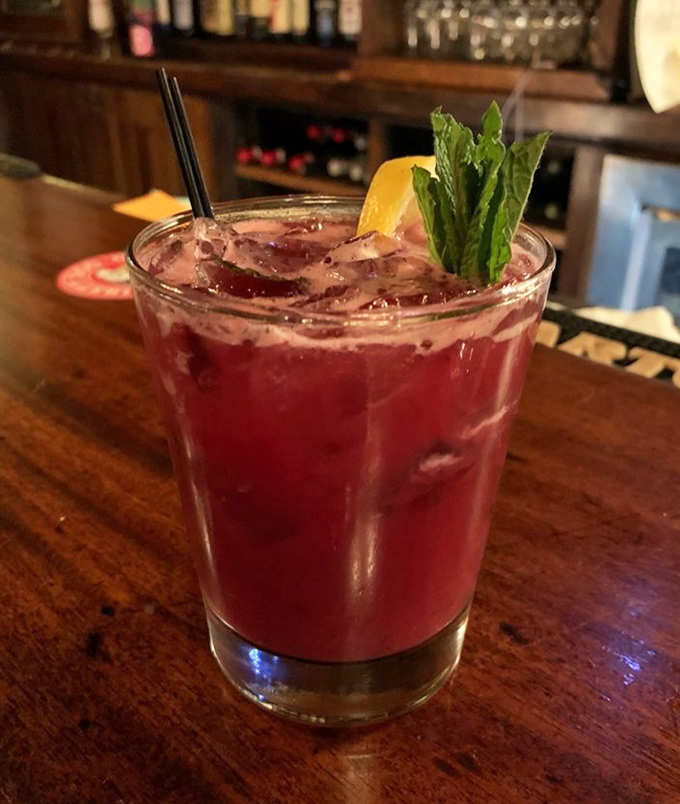 A ruby-red cocktail garnished with fresh mint&mdash;visual proof that Bender's takes its liquid artistry as seriously as its culinary reputation.