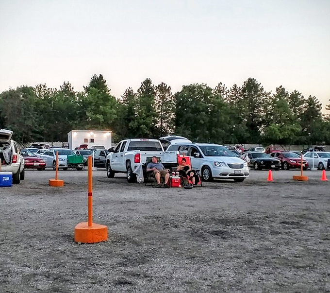 Tailgating meets cinema as families create their own perfect viewing nests, complete with chairs, blankets, and prime parking positions.