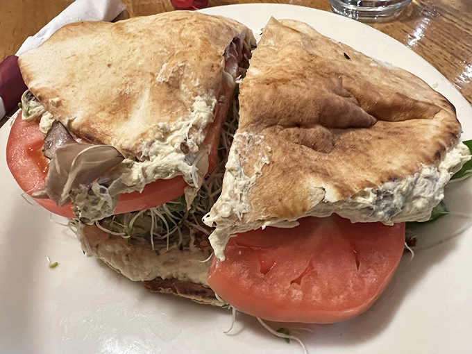 The pita sandwich that launched a thousand return visits—stuffed with fresh veggies and what might be the most perfect falafel this side of the Mediterranean.