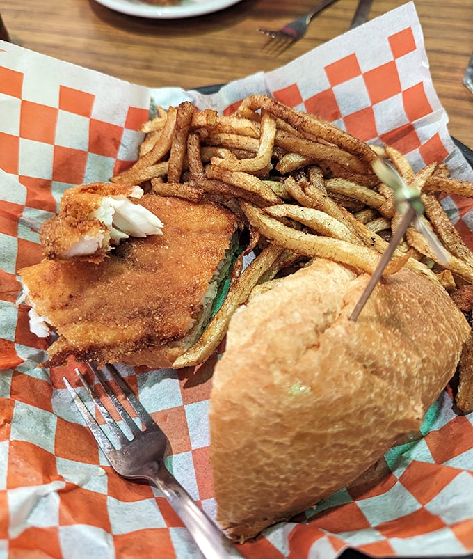 The fish sandwich that launched a thousand return visits, paired with fries that clearly didn't come from a freezer bag.