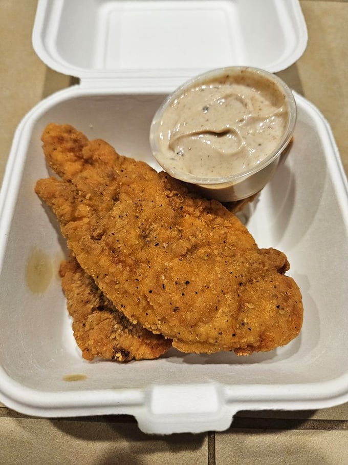 Golden-fried fish fillets with a side of creamy sauce&mdash;proof that sometimes the simplest pleasures are the most satisfying.