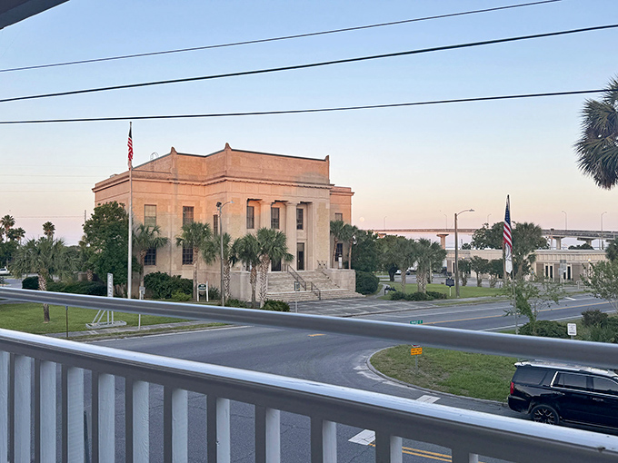The stately Franklin County Courthouse stands sentinel at dusk, its classical columns and palm sentries guarding stories of coastal justice.