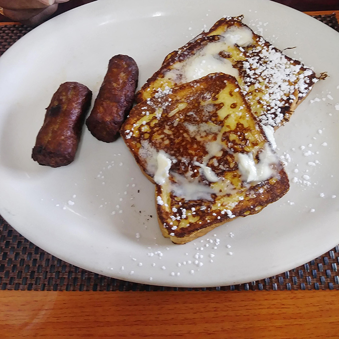 French toast that would make a Parisian jealous. That golden surface and powdered sugar dusting signals the start of a very good day.