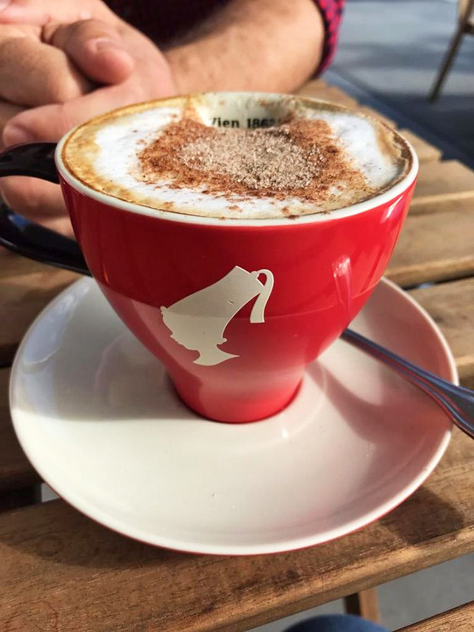 Their cappuccino comes in a cup so red and cheerful it's like starting your day with a caffeinated hug. The foam art is just showing off.