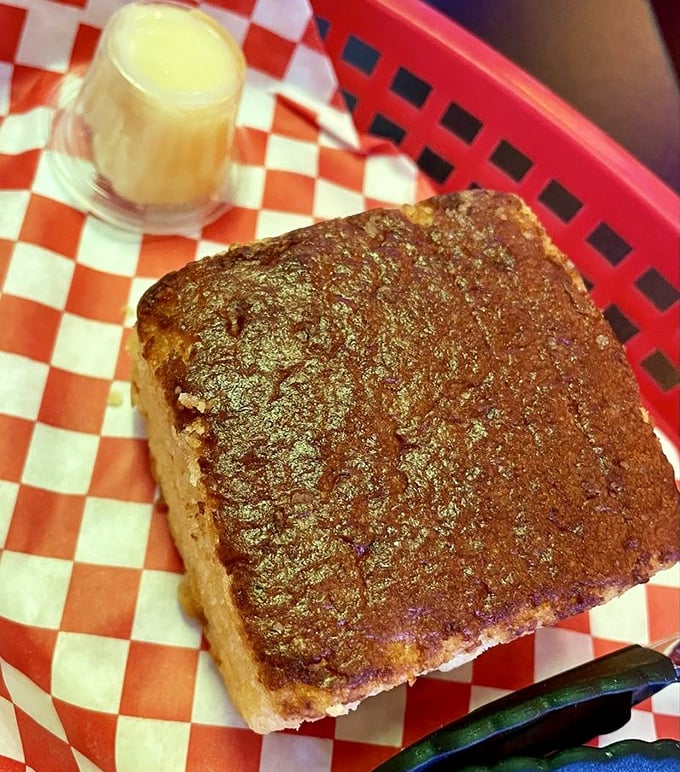 Golden cornbread with honey butter waiting nearby&mdash;the unsung hero of BBQ that deserves its own spotlight and fan club.