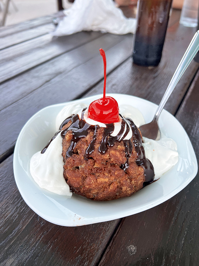 Deep-fried ice cream with chocolate drizzle and a cherry on top&mdash;dessert that perfectly balances "I shouldn't" with "I absolutely must."