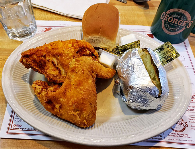 Fried chicken that would make your grandmother both jealous and proud, served with a baked potato wrapped like a precious gift.