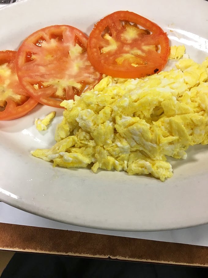 Simple scrambled eggs with fresh tomato slices &ndash; proof that sometimes the classics need no improvement, just proper execution.