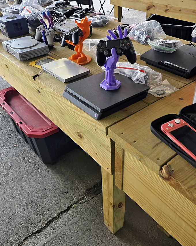 Gaming history displayed chronologically&mdash;from original PlayStations to modern consoles, complete with quirky figurines standing guard.