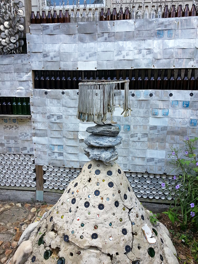Beyond the house, the garden pathways incorporate bottle caps and marbles, creating a mosaic effect that would make Gaud&iacute; raise his glass.
