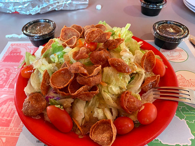 A proper garden salad with crisp vegetables and cheese that says, "Yes, we're a pizza place, but we respect the importance of roughage."