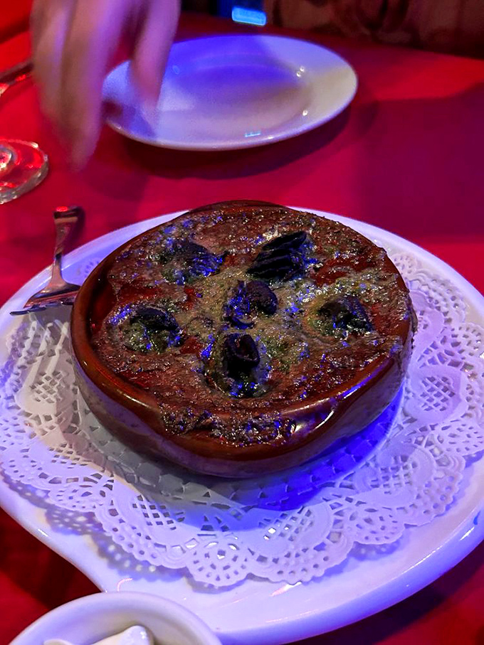 Blue flames dancing atop escargot? That's not just dinner, that's dinner and a show in one delicious ceramic dish.