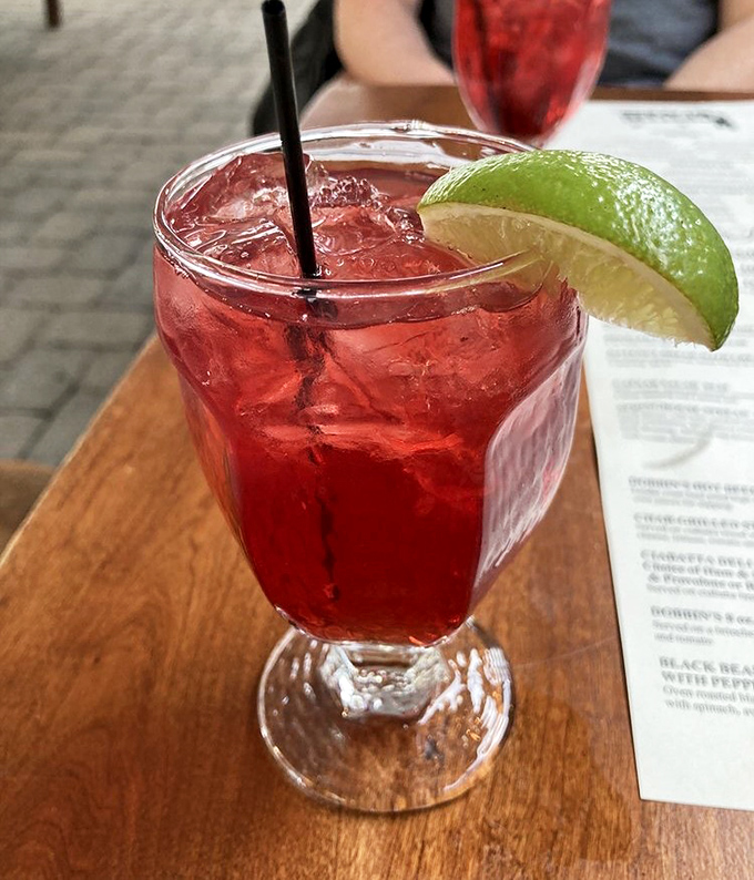 Ruby red refreshment with a lime twist &ndash; proof that the pursuit of happiness sometimes comes in a glass with ice and a splash of colonial inspiration.