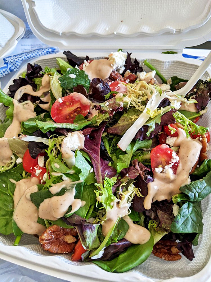 A salad that actually excites: fresh greens, vibrant tomatoes, and goat cheese that didn't come from just any old billy.