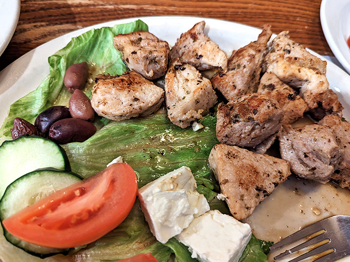 A Greek salad that balances virtue and indulgence, where grilled chicken and feta prove healthy choices needn't be punishment.