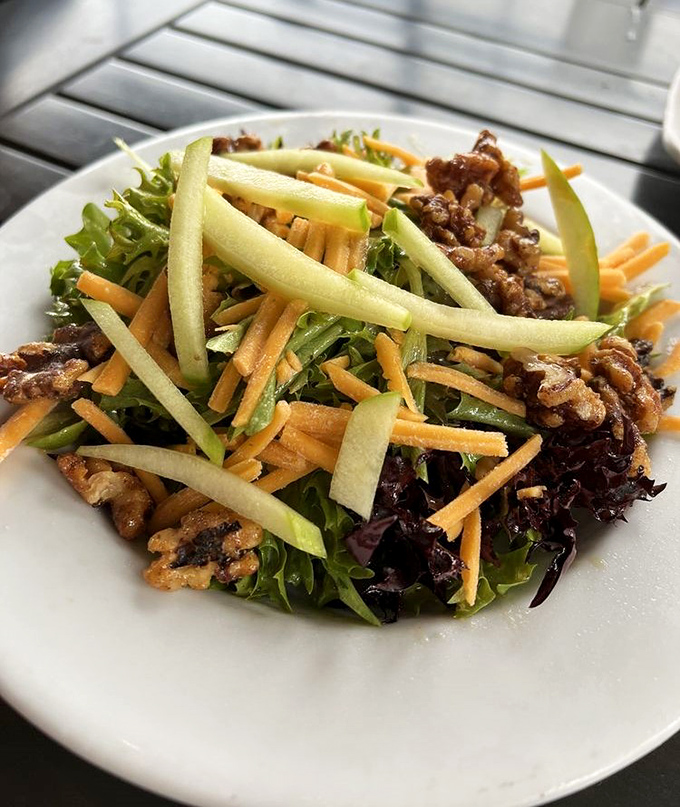 Fresh greens, candied walnuts, and colorful vegetables create a salad that's anything but an afterthought on this menu.