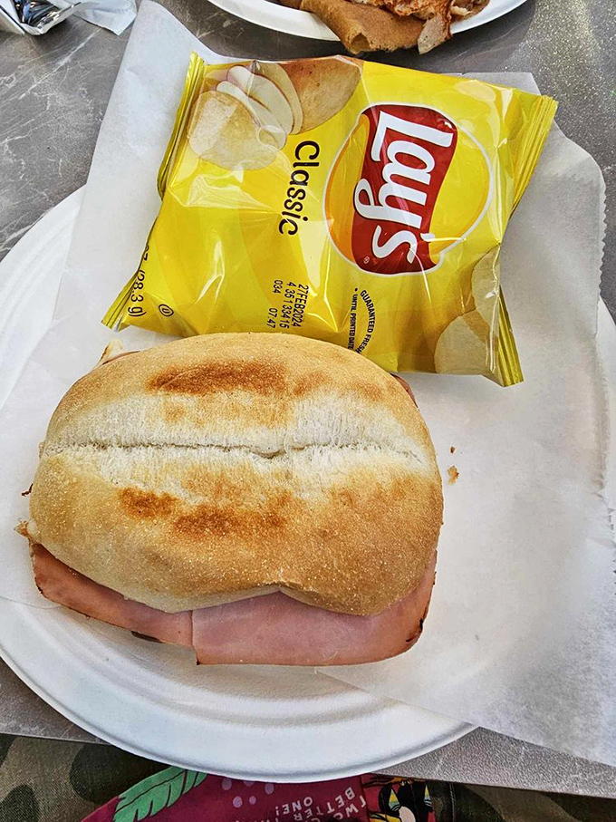 Sometimes simplicity wins the day—a classic ham sandwich paired with chips makes lunch feel like a European holiday.