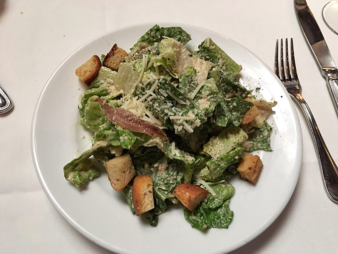 Even the Caesar salad gets the royal treatment—crisp romaine, proper dressing, and croutons that actually taste like bread, not cardboard.