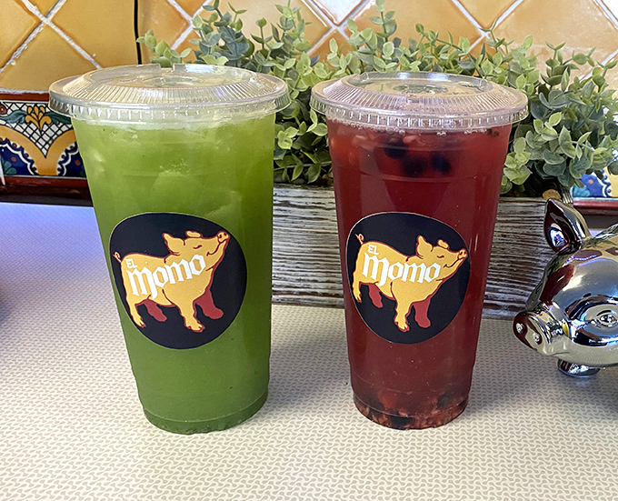 Aguas frescas in vibrant green and ruby red&mdash;nature's perfect counterpoint to rich carnitas. These aren't just drinks; they're liquid refreshment art.