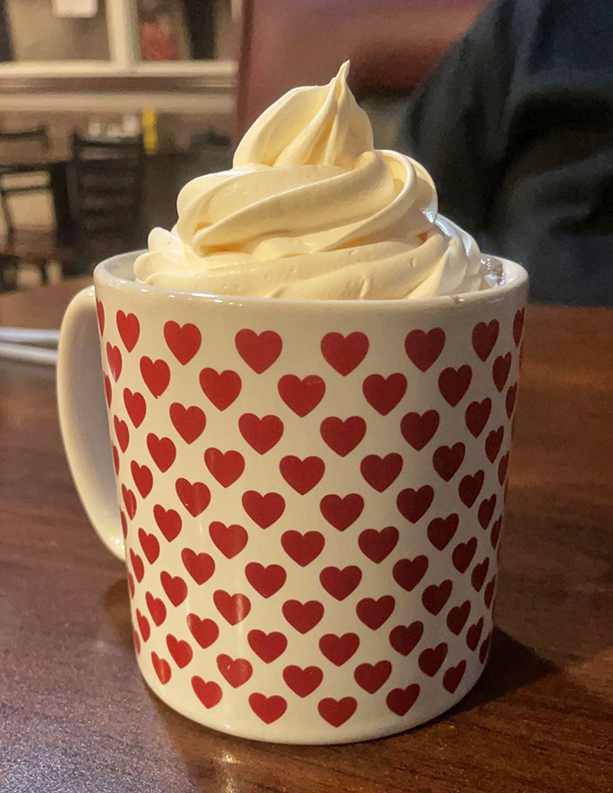 That heart-covered mug isn't just serving hot chocolate&mdash;it's delivering a warm hug in liquid form, topped with a cloud of whipped cream.