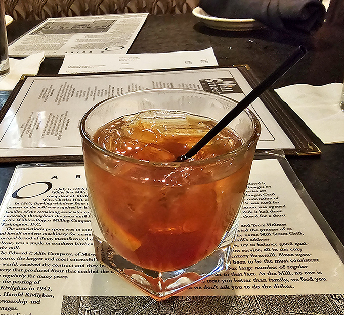 An old-fashioned iced tea sits ready to refresh, while the menu in the background hints at the delicious decisions that lie ahead.