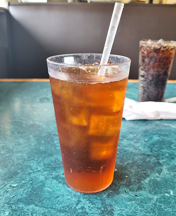 Iced tea so perfectly amber it could be mistaken for liquid topaz. The condensation on the glass promises refreshment that no fancy cocktail can match.