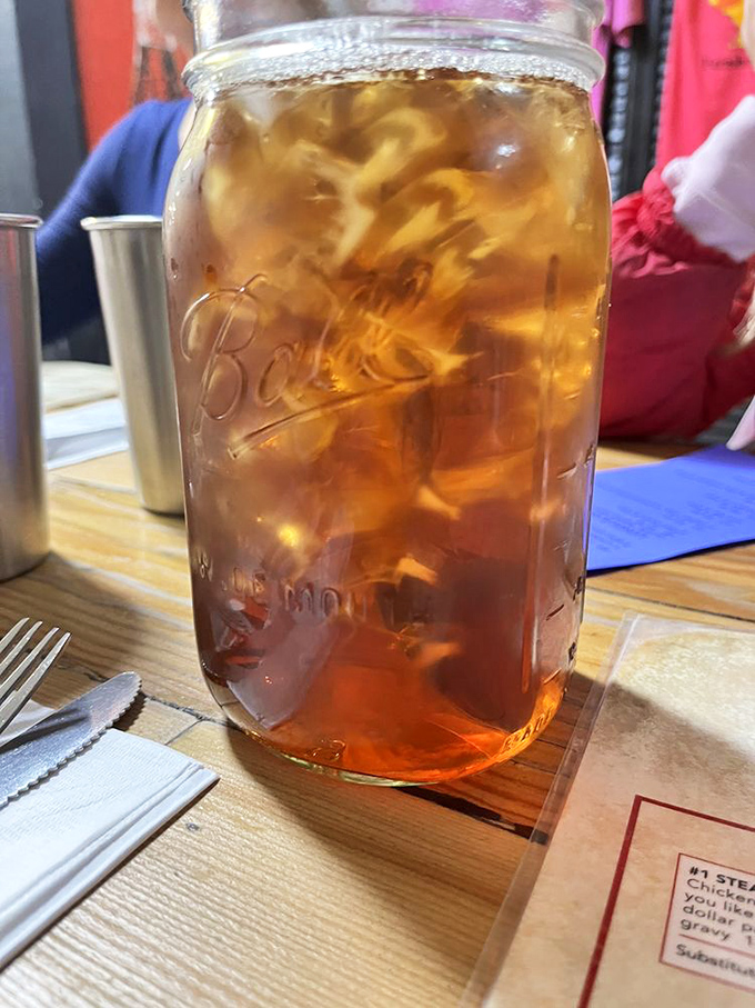 Sweet tea served in a Mason jar&mdash;because in the South, proper hydration comes with enough sugar to make your dentist wince.