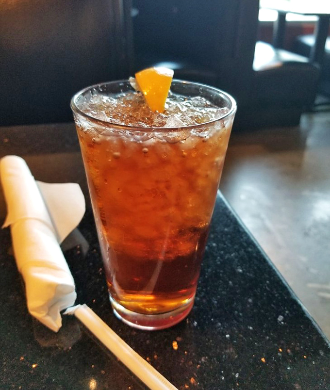 Sweet tea: the champagne of the South, served properly over ice with an orange slice. Essential hydration for serious barbecue sessions.