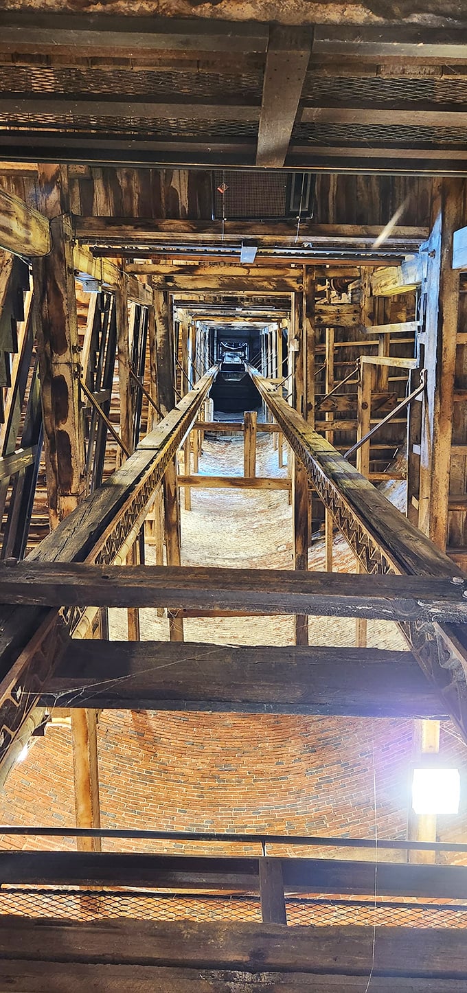 Looking up from inside is like peering through time's telescope. The wooden framework creates a dizzying path that molten lead once traveled to become perfect spheres.