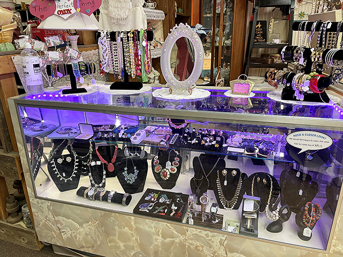 Under purple lights, yesterday's jewelry waits for tomorrow's special occasions. Rhinestones and pearls that have seen more history than most textbooks.