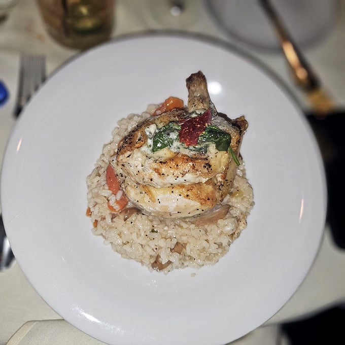 This isn't just chicken—it's a perfectly seared airline breast perched atop a bed of risotto, showing that non-beef options aren't mere afterthoughts.