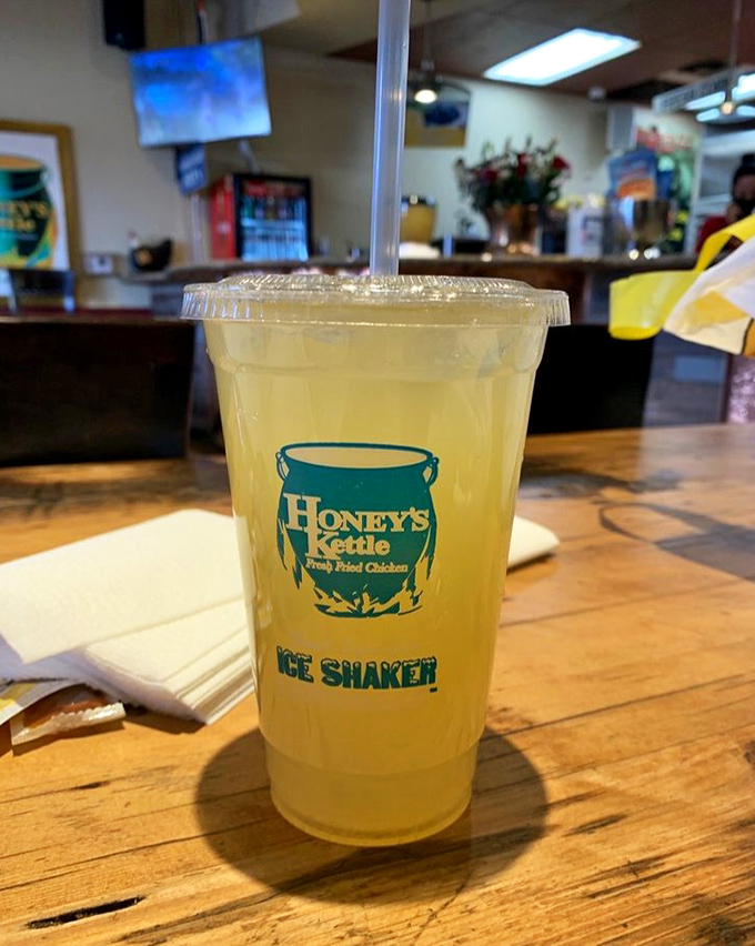 Sunshine in a cup with the Honey's Kettle logo promising authenticity. This lemonade isn't just a drink—it's the perfect palate refresher between bites of crispy chicken.